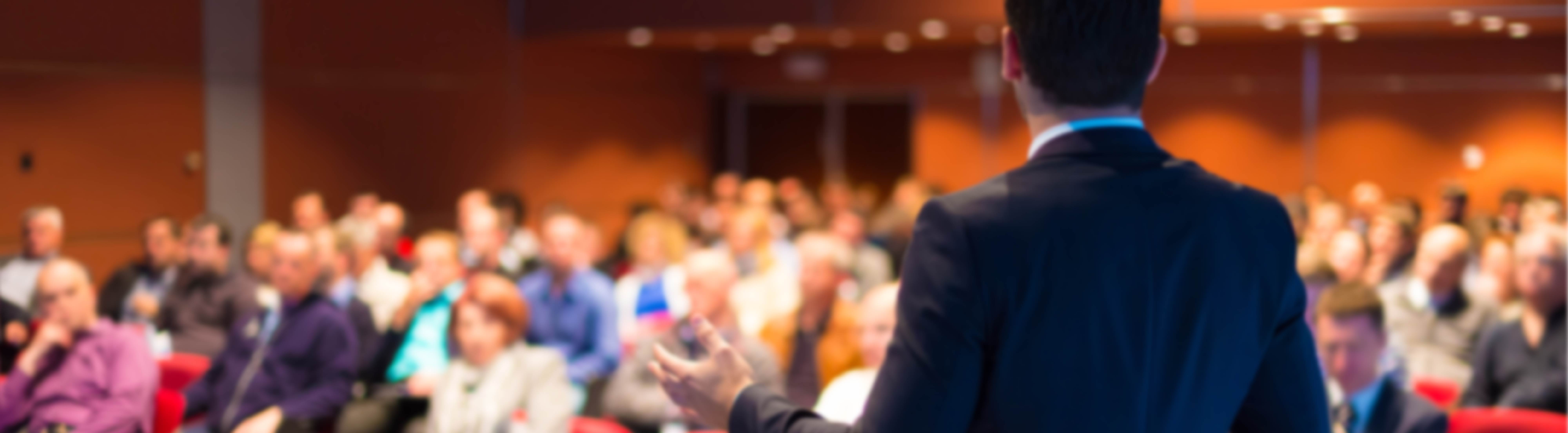 Male speaker addressing a crowd - Touchpoint Event & Delegate Solutions