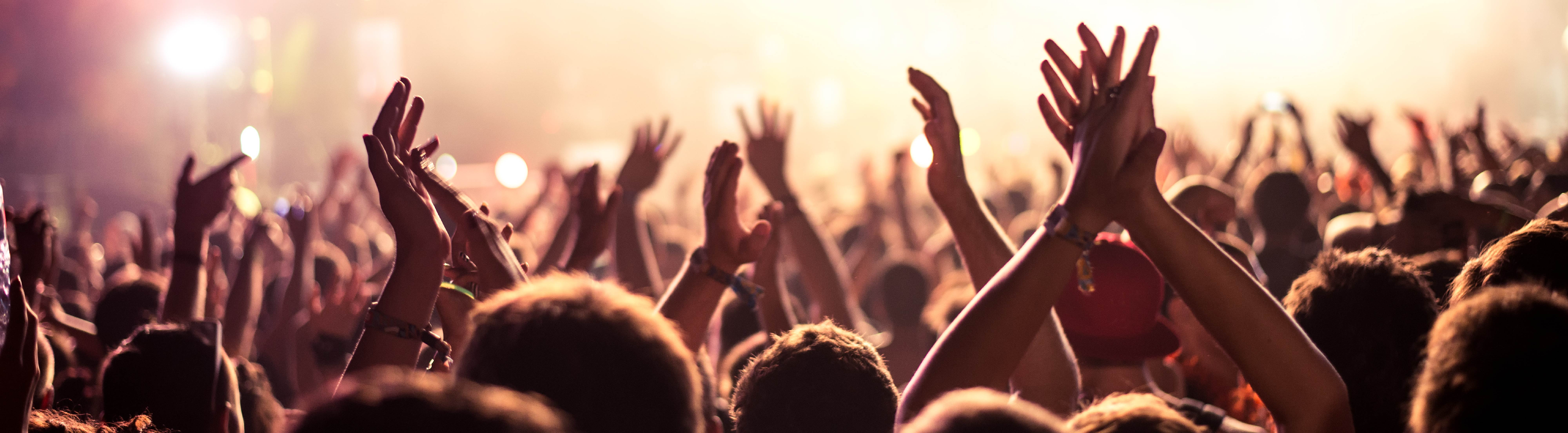 People with raised hands facing a stage - Touchpoint Event & Delegate ...